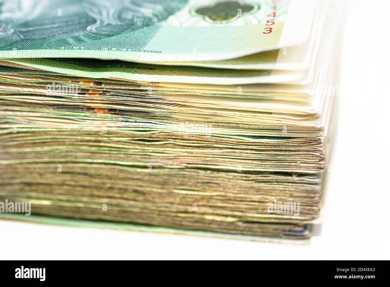 A pile of stacked 100 Polish zloty paper banknotes, isolated on a white ...