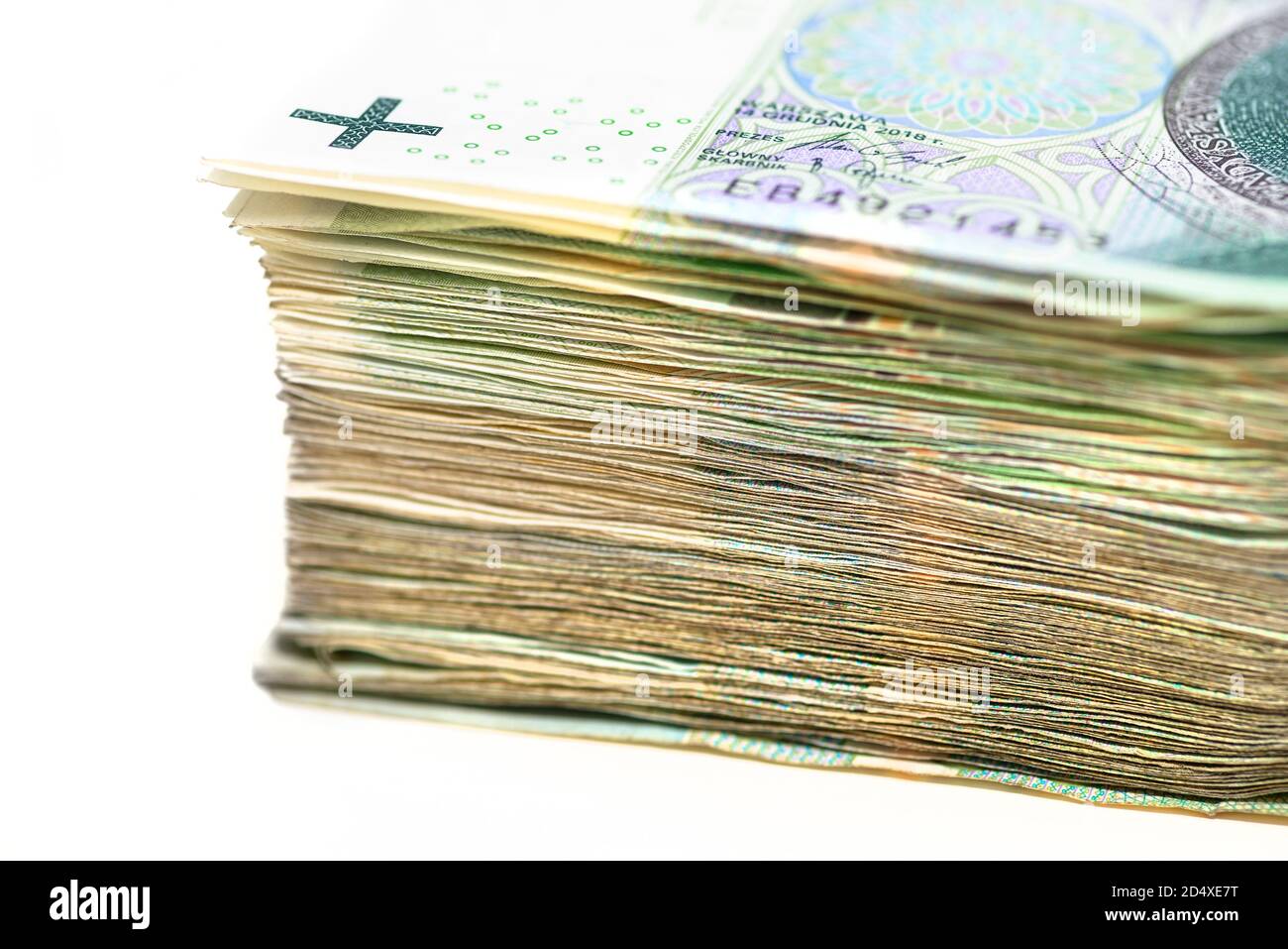 A pile of stacked 100 Polish zloty paper banknotes, isolated on a white ...