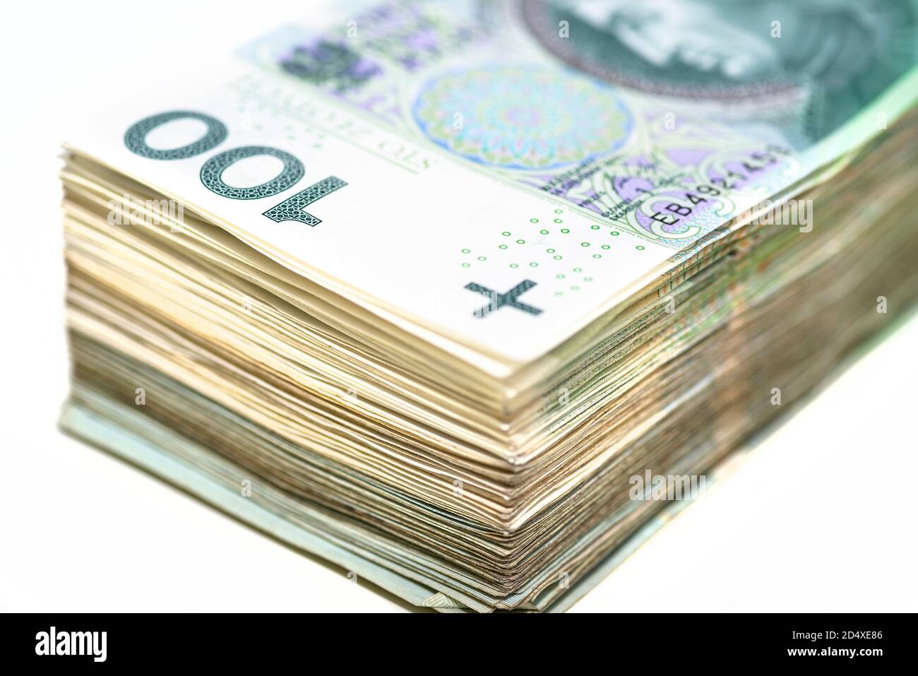 A pile of stacked 100 Polish zloty paper banknotes, isolated on a white ...
