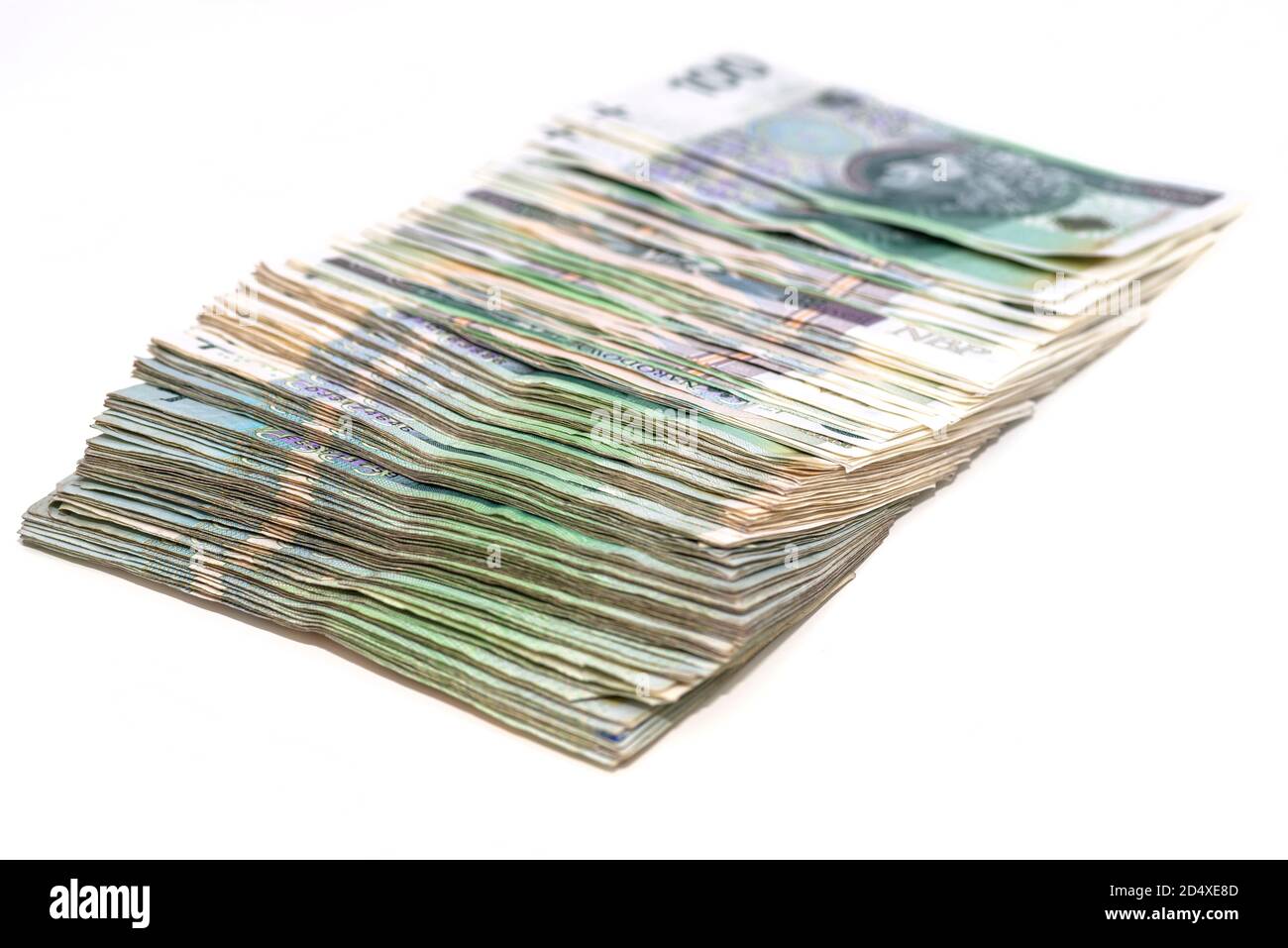 A pile of scattered 100 Polish zloty paper banknotes, isolated on a ...
