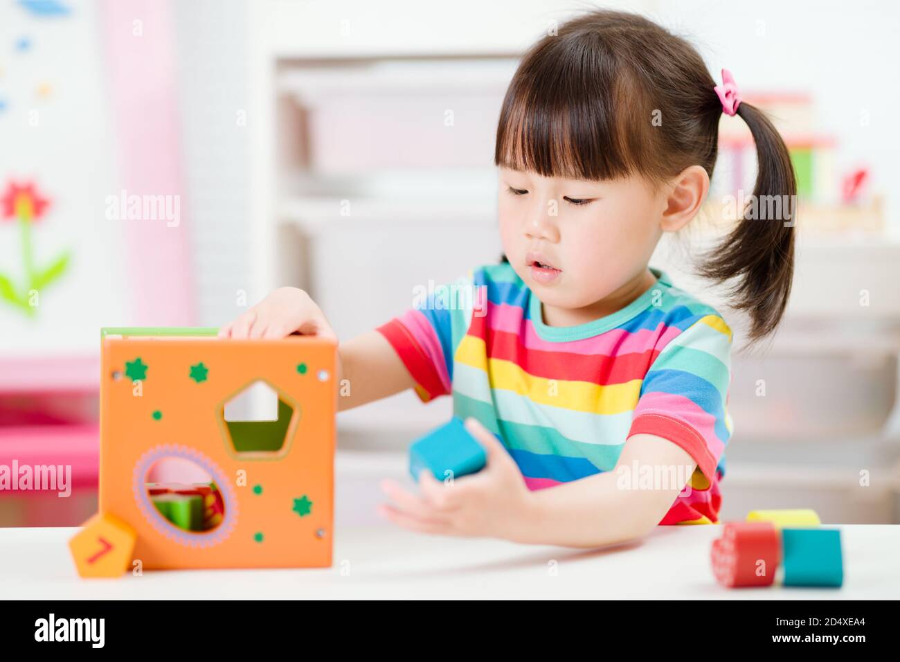 young girl playing number shape blocks for homeschooling Stock Photo ...