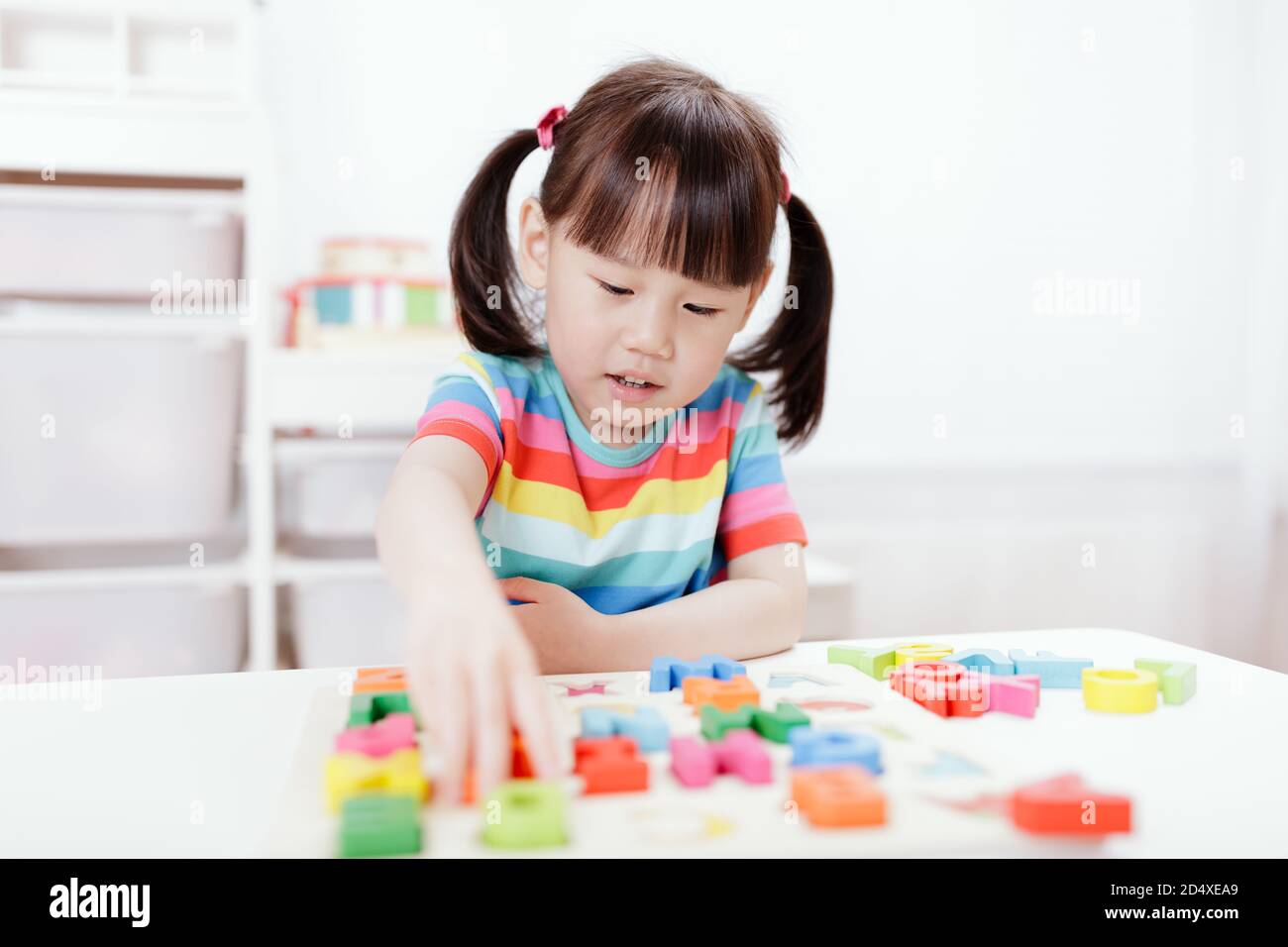 young girl learning letter blocks for homeschooling Stock Photo - Alamy