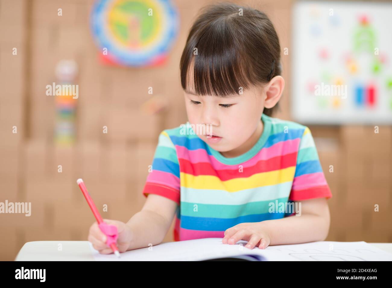 young girl practice drawing different shapes for homeschooling Stock ...
