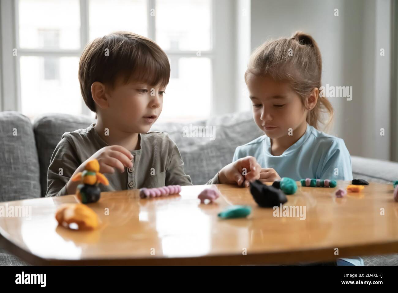 Little children have fun play with playdough Stock Photo - Alamy