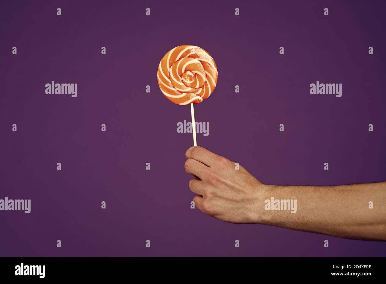 Sweet trap. Lollipop close up. Hand hold lollipop. Sweet gift. Gift for ...