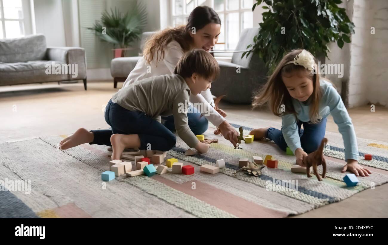 Playful mom and little children play at home Stock Photo - Alamy