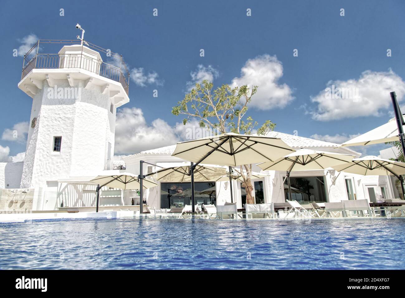hotel building house white color with lighthouse umbrellas and beach ...