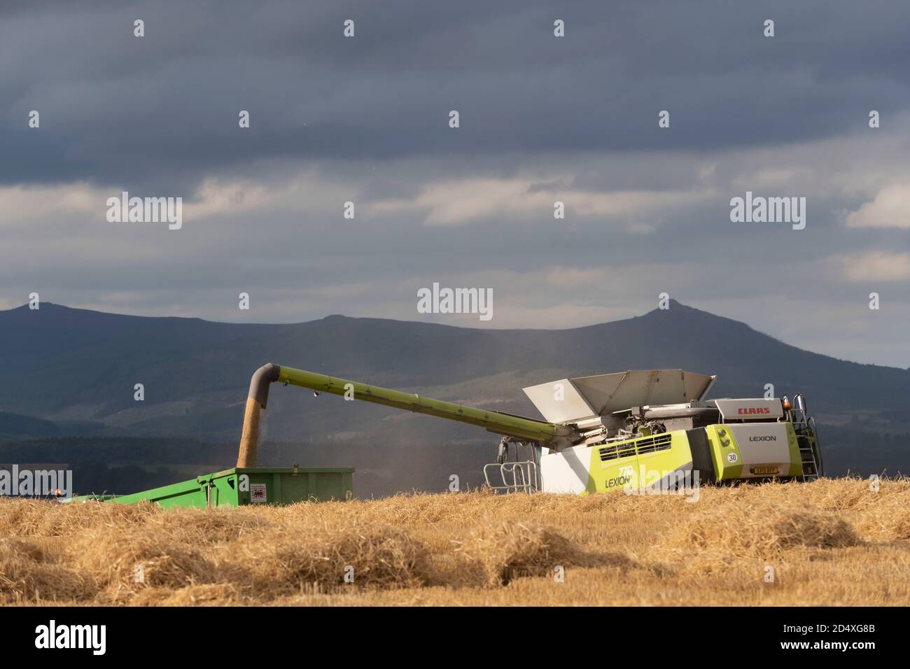 A View Towards Bennachie with a Combine Harvester Loading Grain (Barley ... A View Towards Bennachie with a Combine Harvester Loading Grain (Barley ...