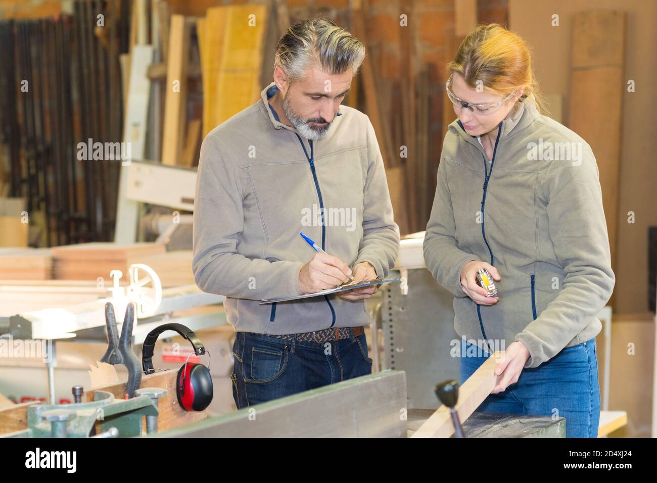 carpentry supervisor getting data from the female carpenter Stock Photo ...
