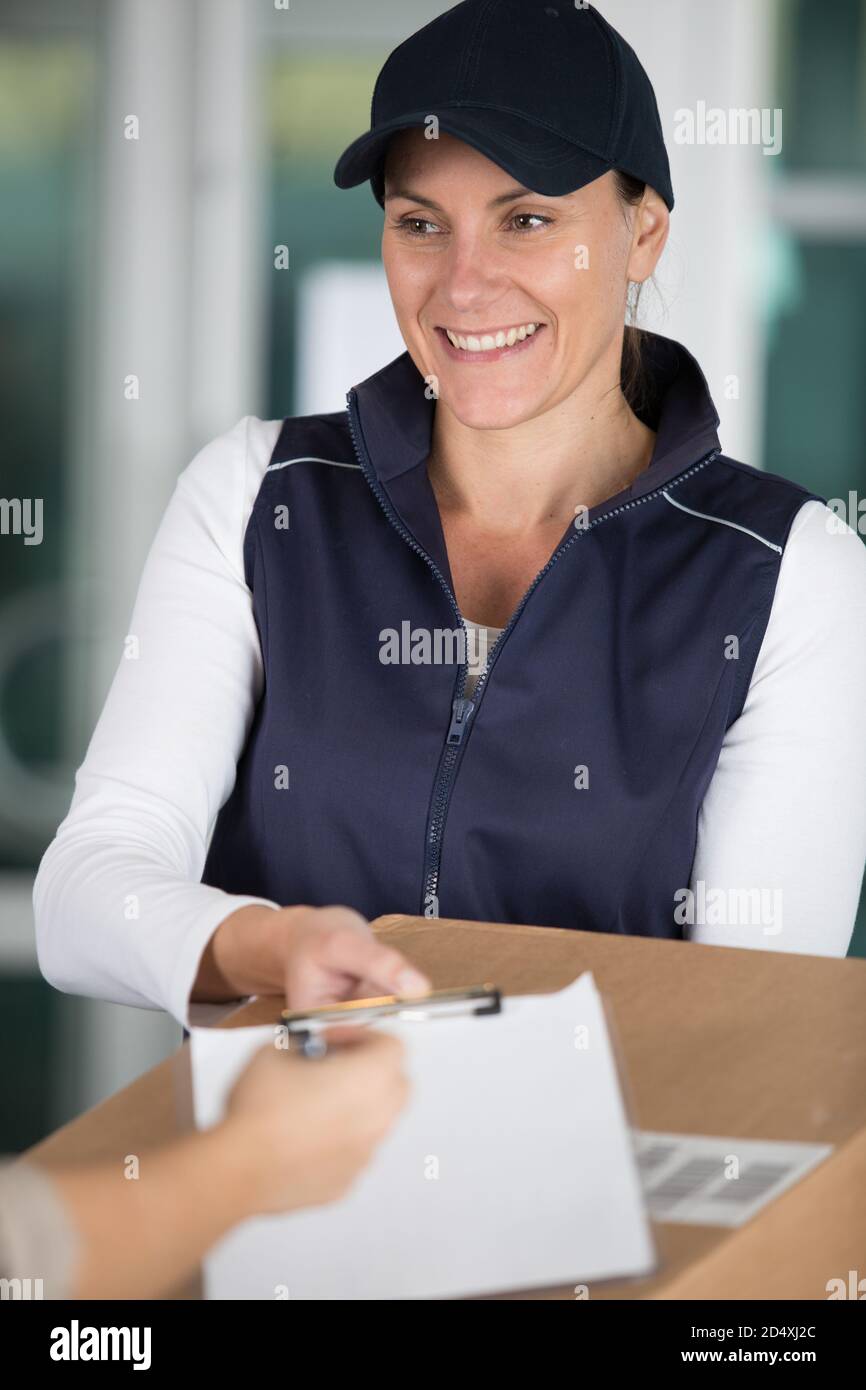 delivery woman handing package to customer Stock Photo - Alamy