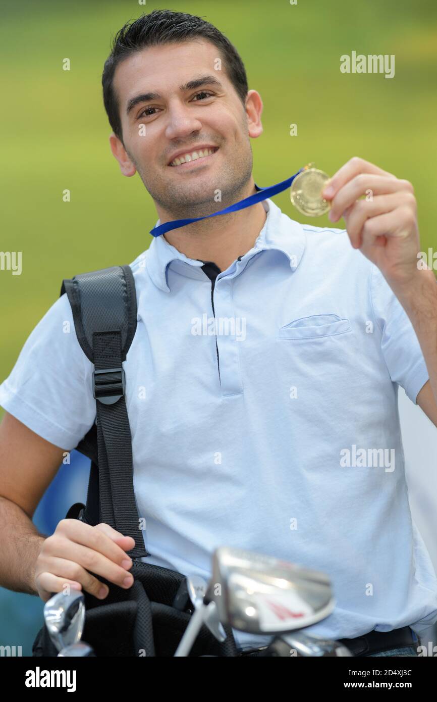 golf medal winner looking at camera proudly Stock Photo - Alamy