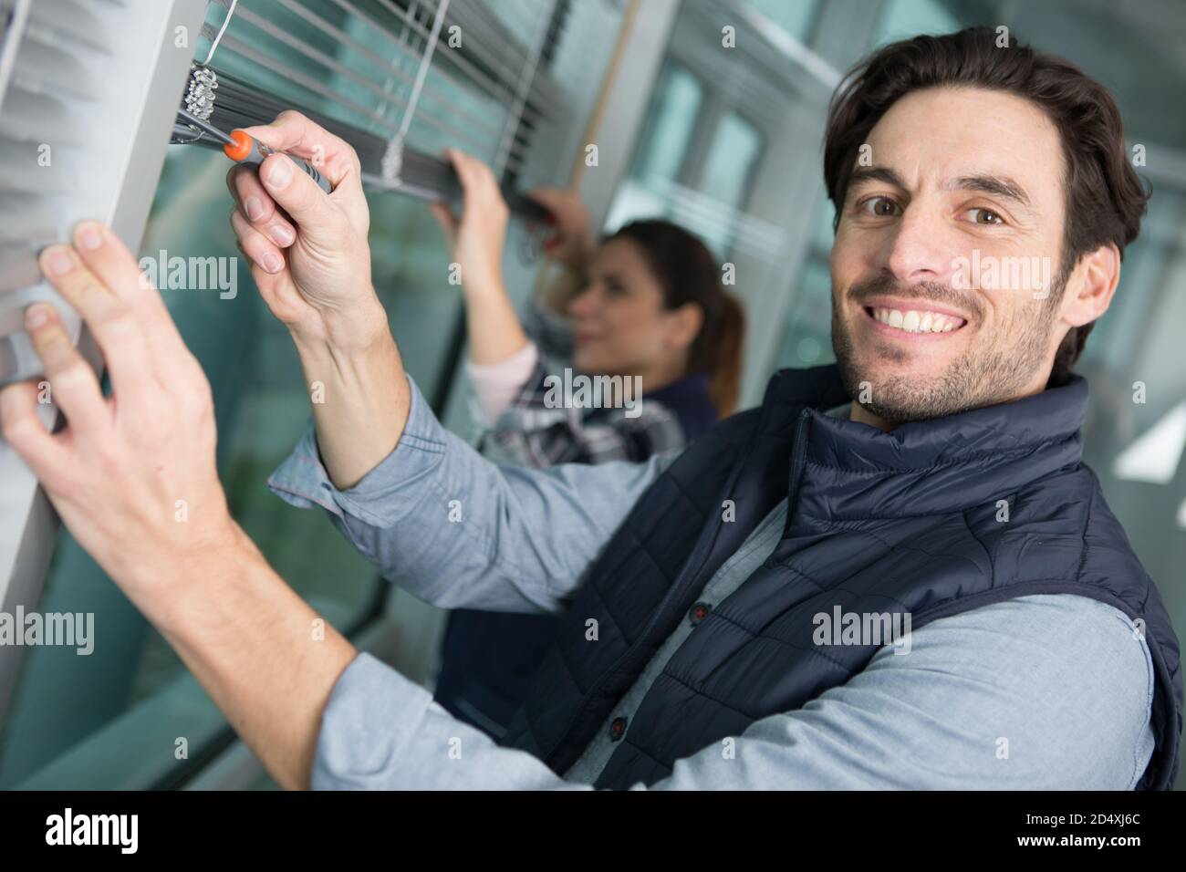close-up of a male repairman fixing window with screwdriver Stock Photo ...