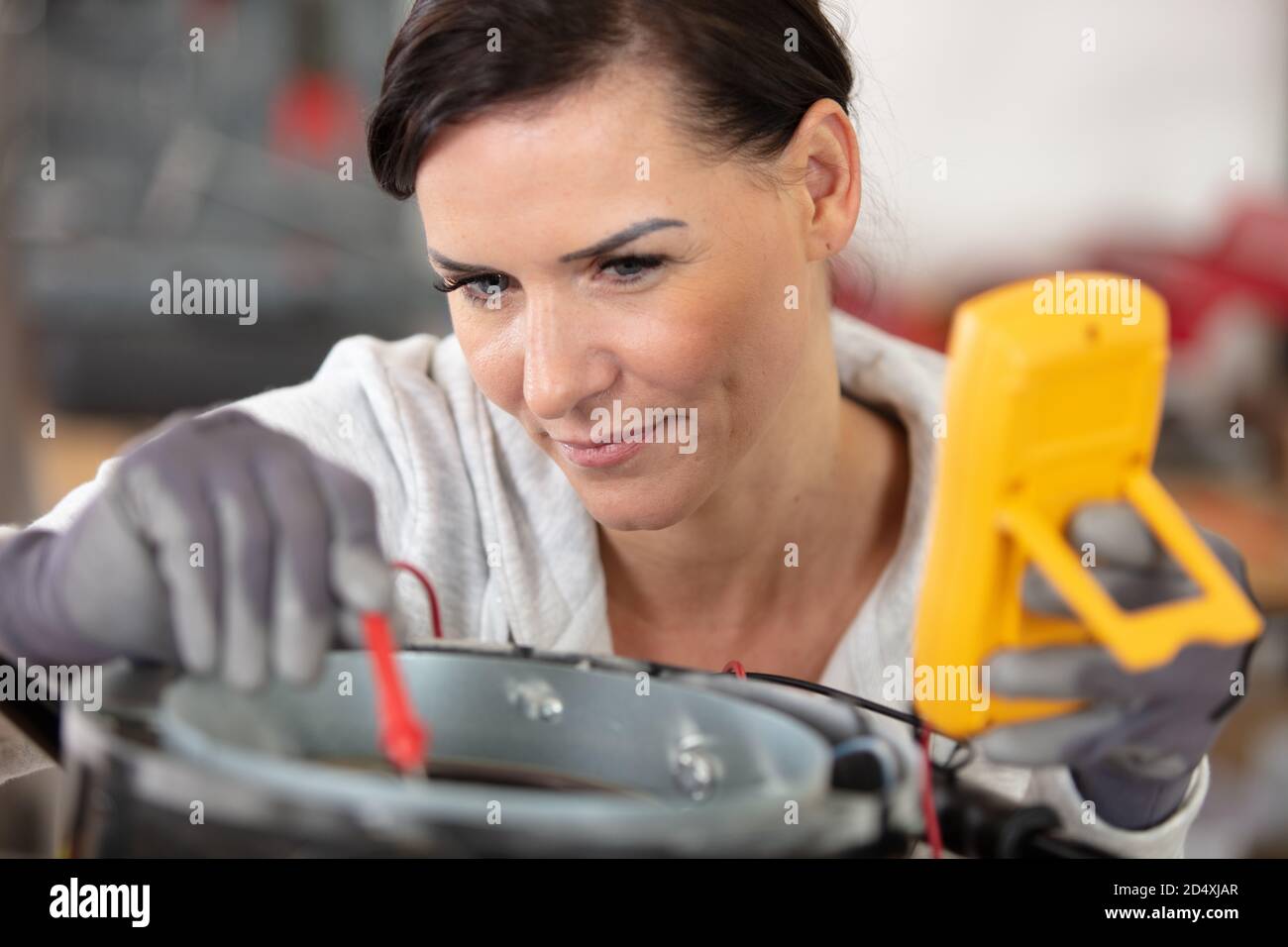 female computer technician using multimeter Stock Photo - Alamy