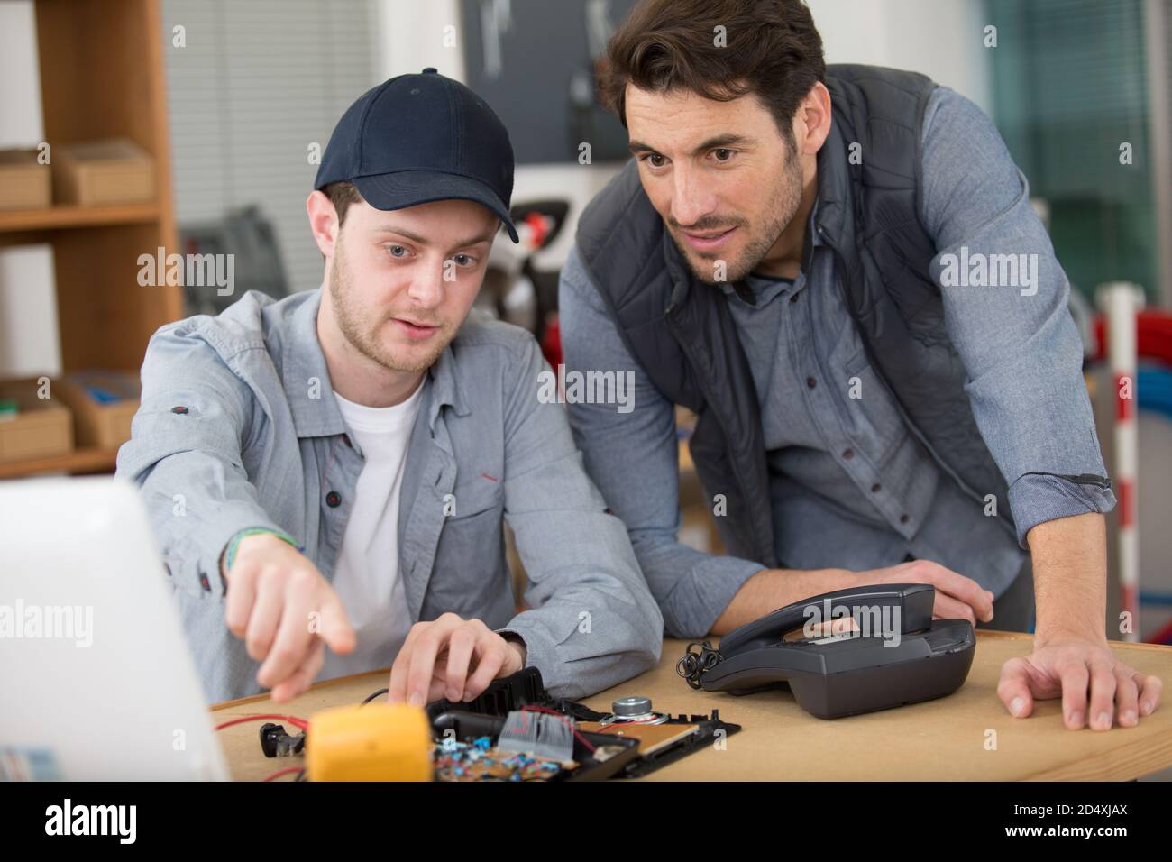 student technician with dismantled telephone Stock Photo - Alamy