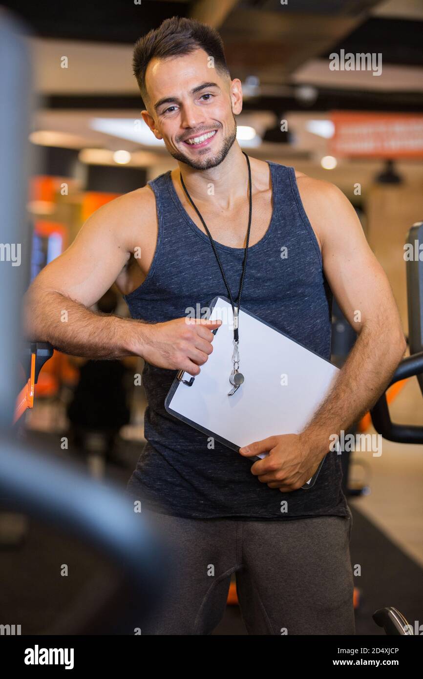 happy male gym instructor looking at camera Stock Photo - Alamy