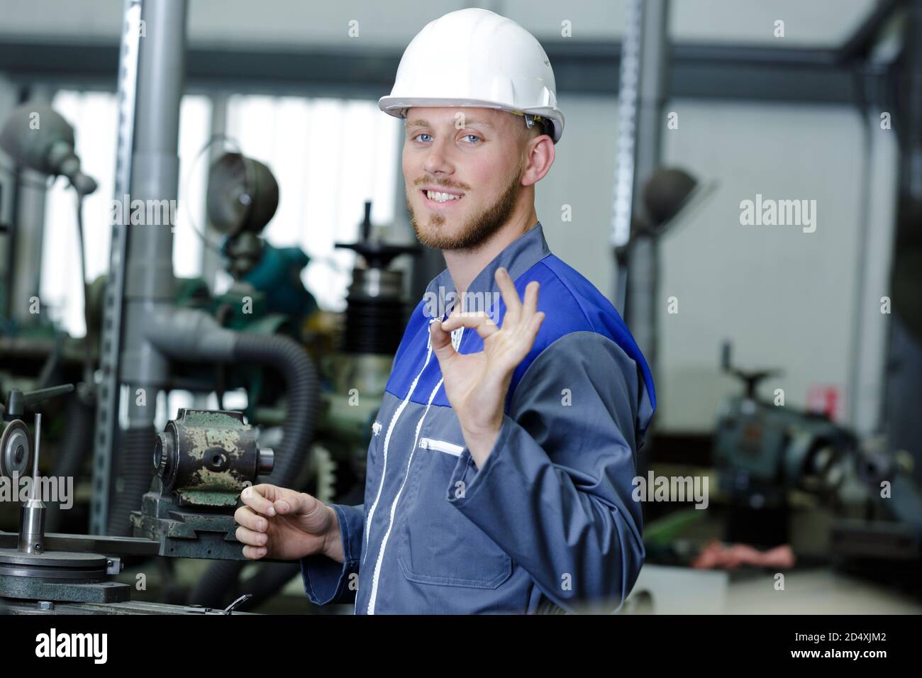 machinist posing with okay signal Stock Photo - Alamy