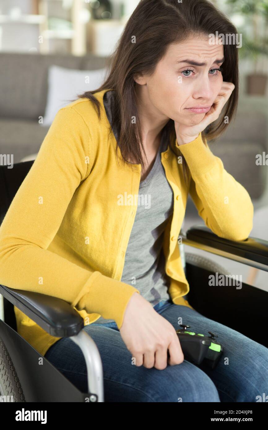miserable woman in a wheelchair has lost the computer game Stock Photo ...