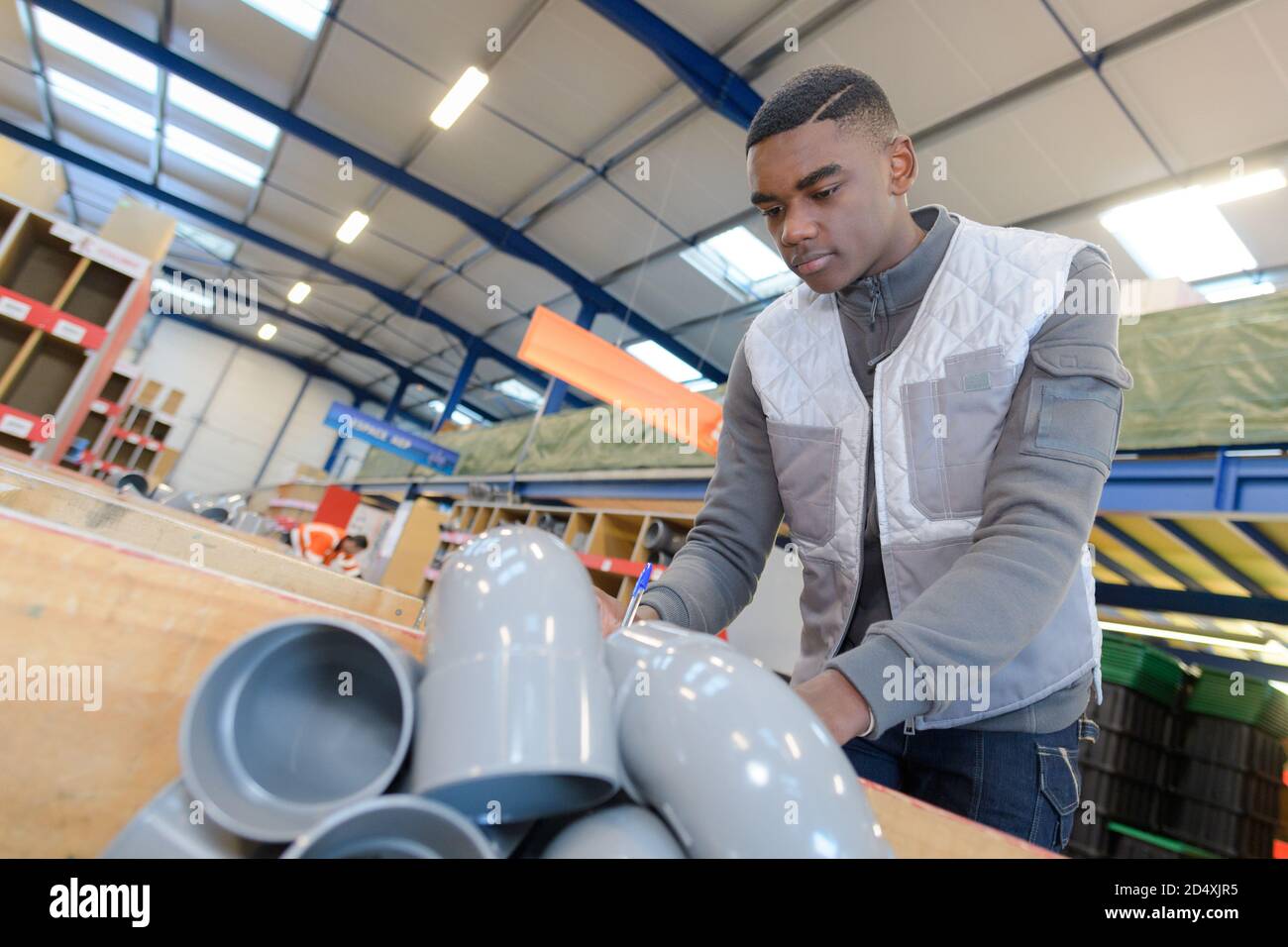 plumber choose pvc pipes from bundle Stock Photo - Alamy
