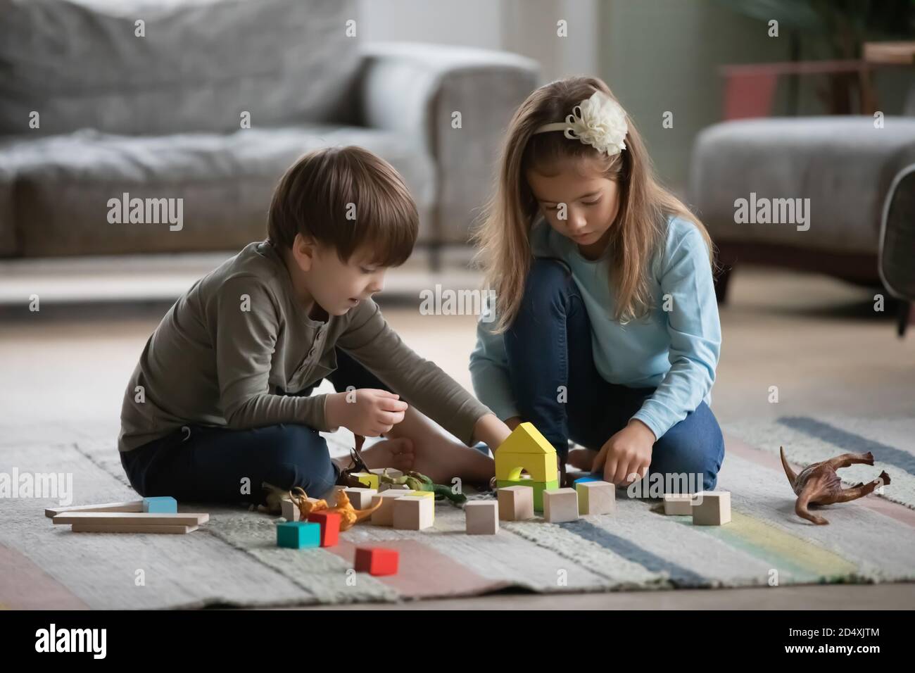 Small children sit at home play with bricks together Stock Photo - Alamy