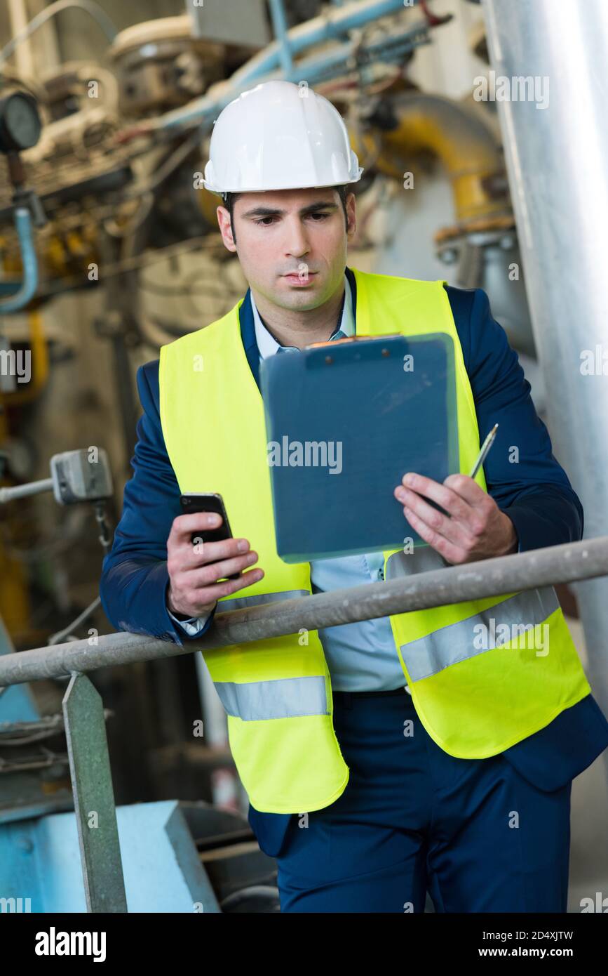portrait of engineer taking notes at control room Stock Photo - Alamy