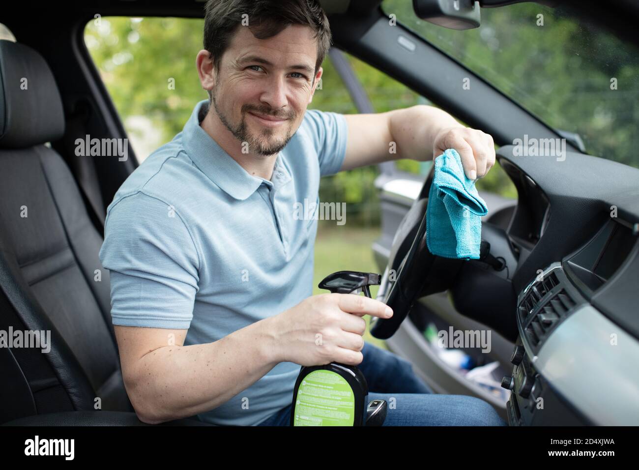 happy man cleans a car inside Stock Photo - Alamy