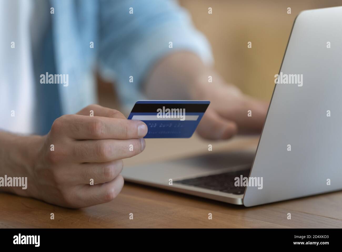Close up young man holding banking card in hands Stock Photo - Alamy