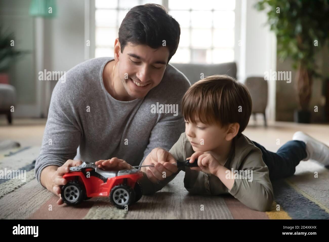 Caring dad play with cars with small preschooler son Stock Photo - Alamy