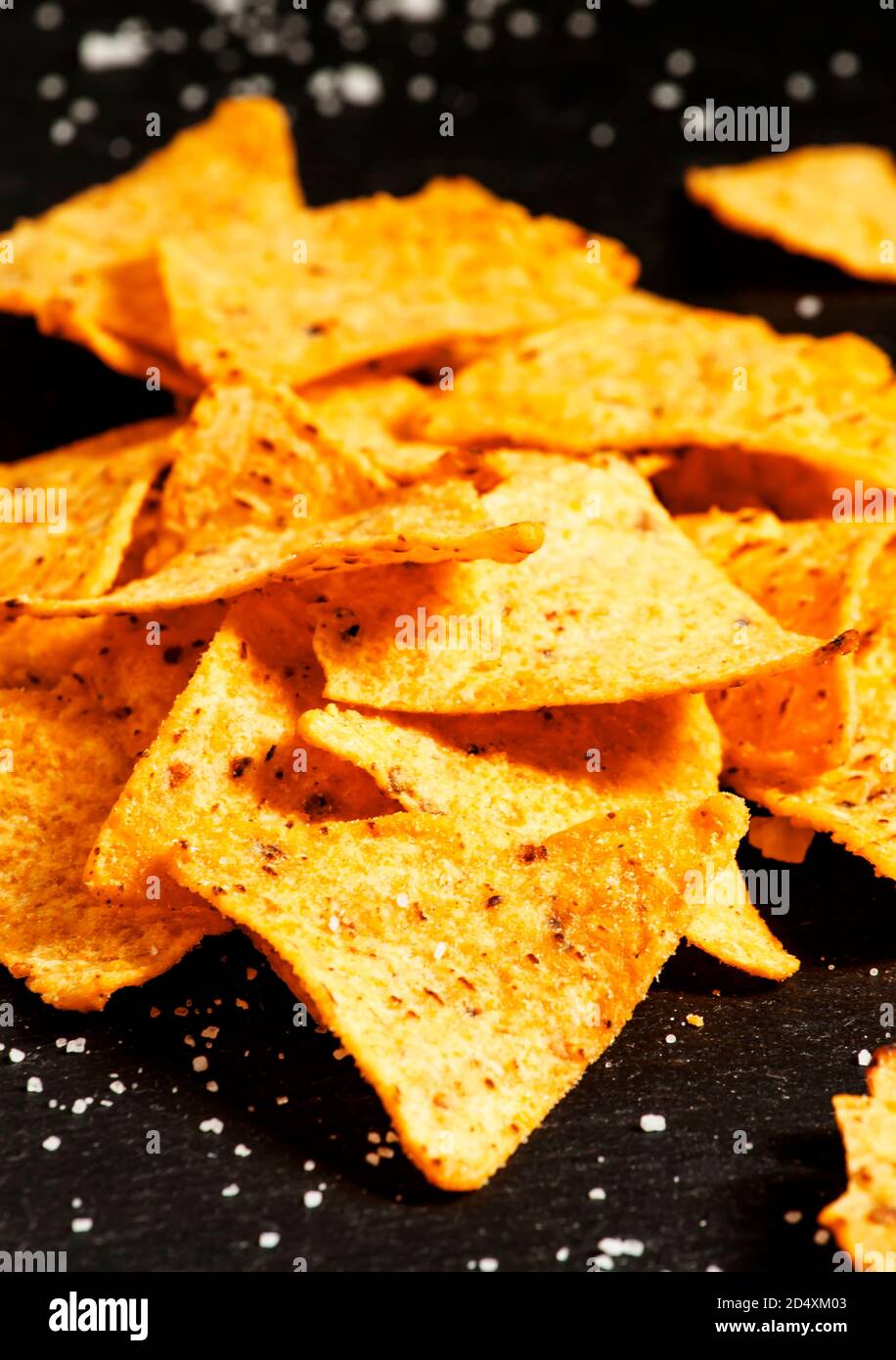 Nachos and salt on a dark background, selective focus Stock Photo - Alamy