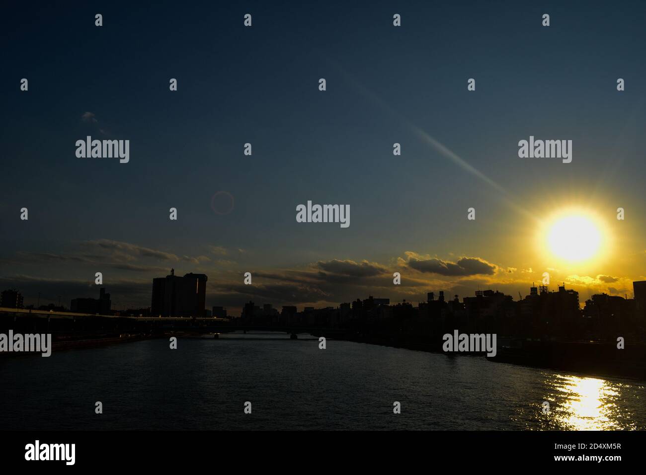 Tokyo, Japan-3/01/16: Beautiful sun setting behind the dark silhouette ...