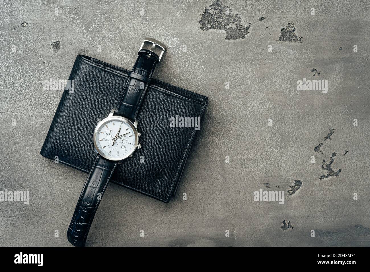 Male watch and leather wallet on dark grey surface Stock Photo - Alamy