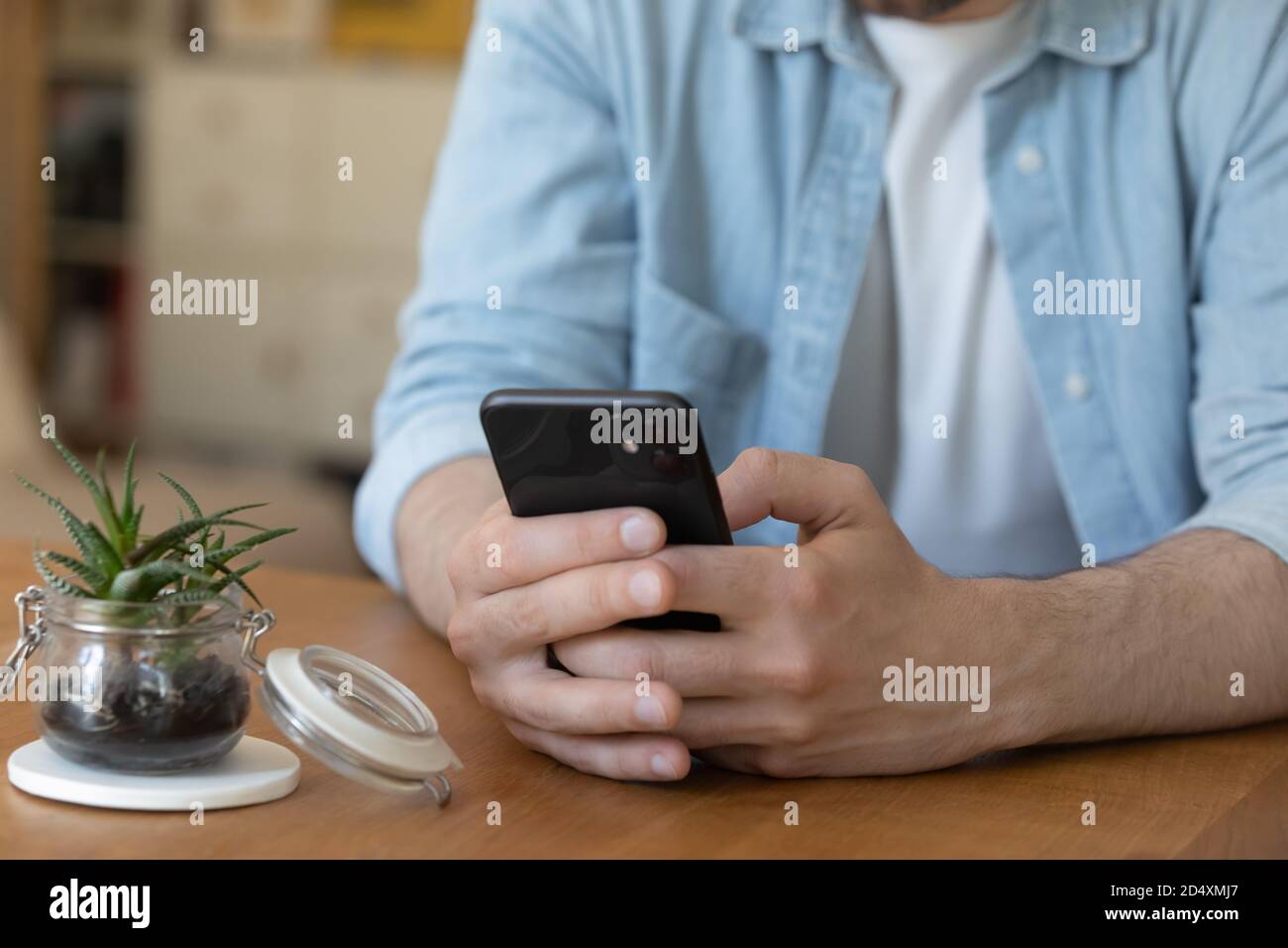 Close up young man holding electronic device in hands Stock Photo - Alamy