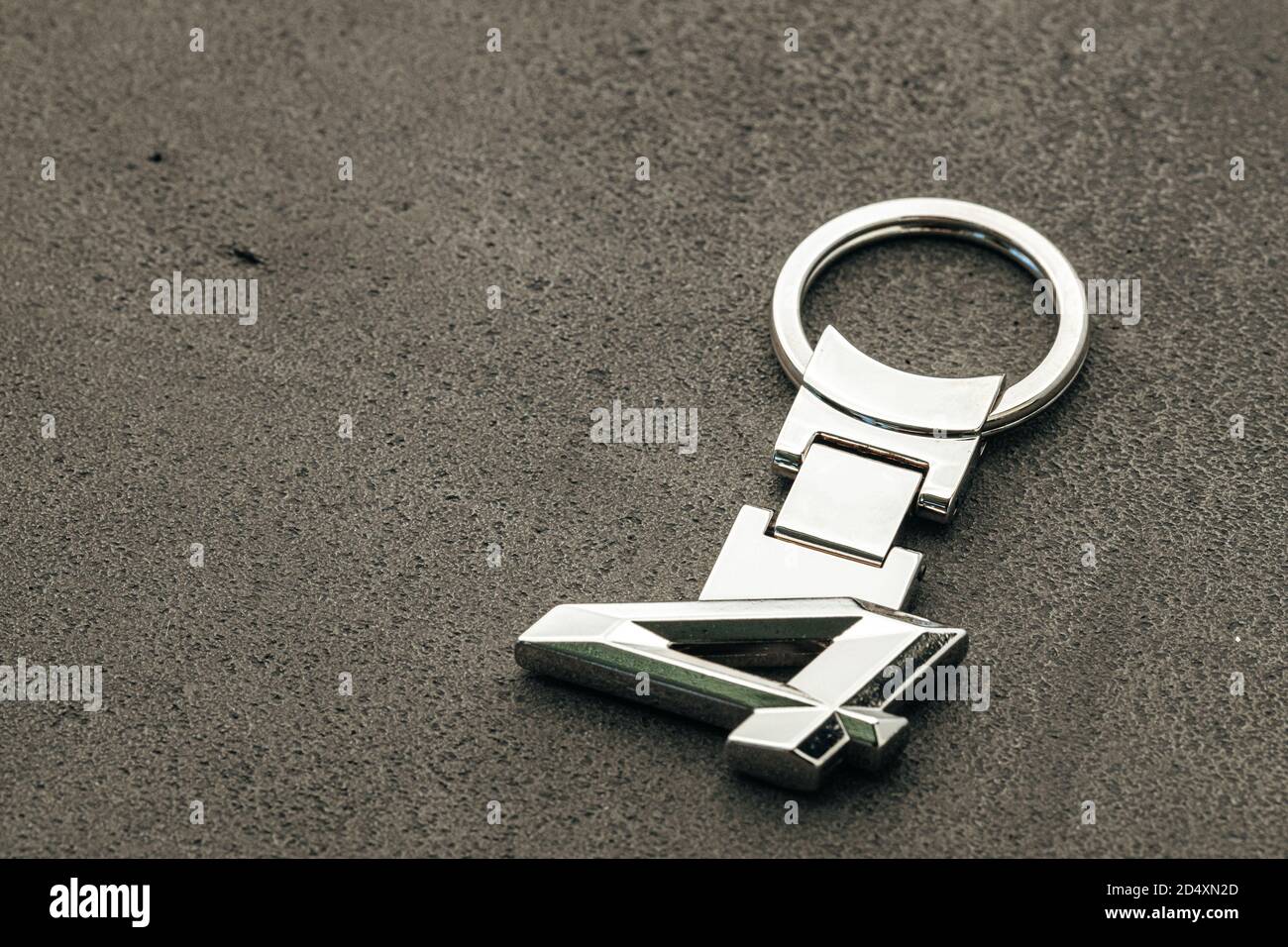 Metal number Four car key on dark concrete background Stock Photo - Alamy