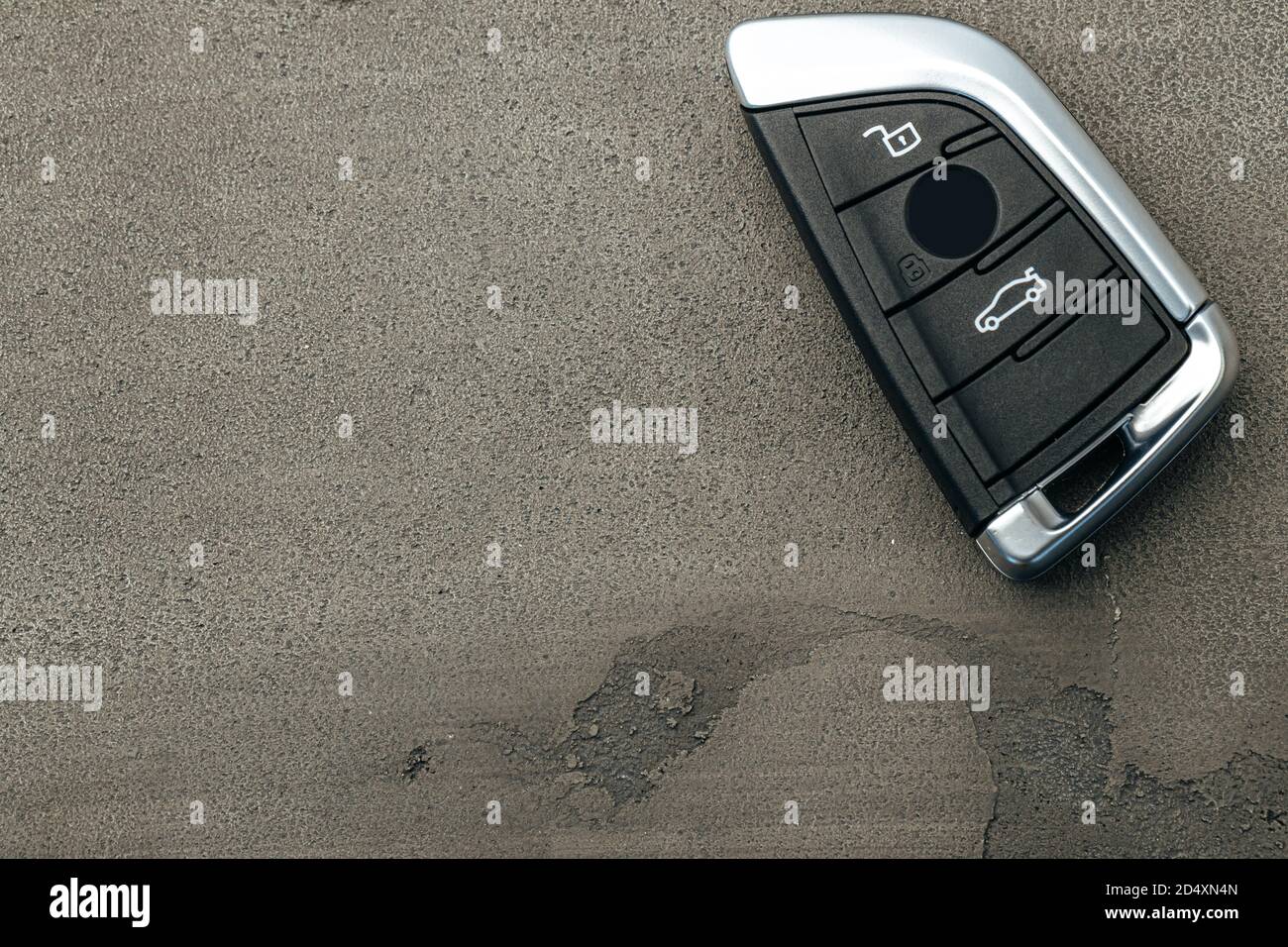 Modern automobile car key on black concrete background Stock Photo - Alamy