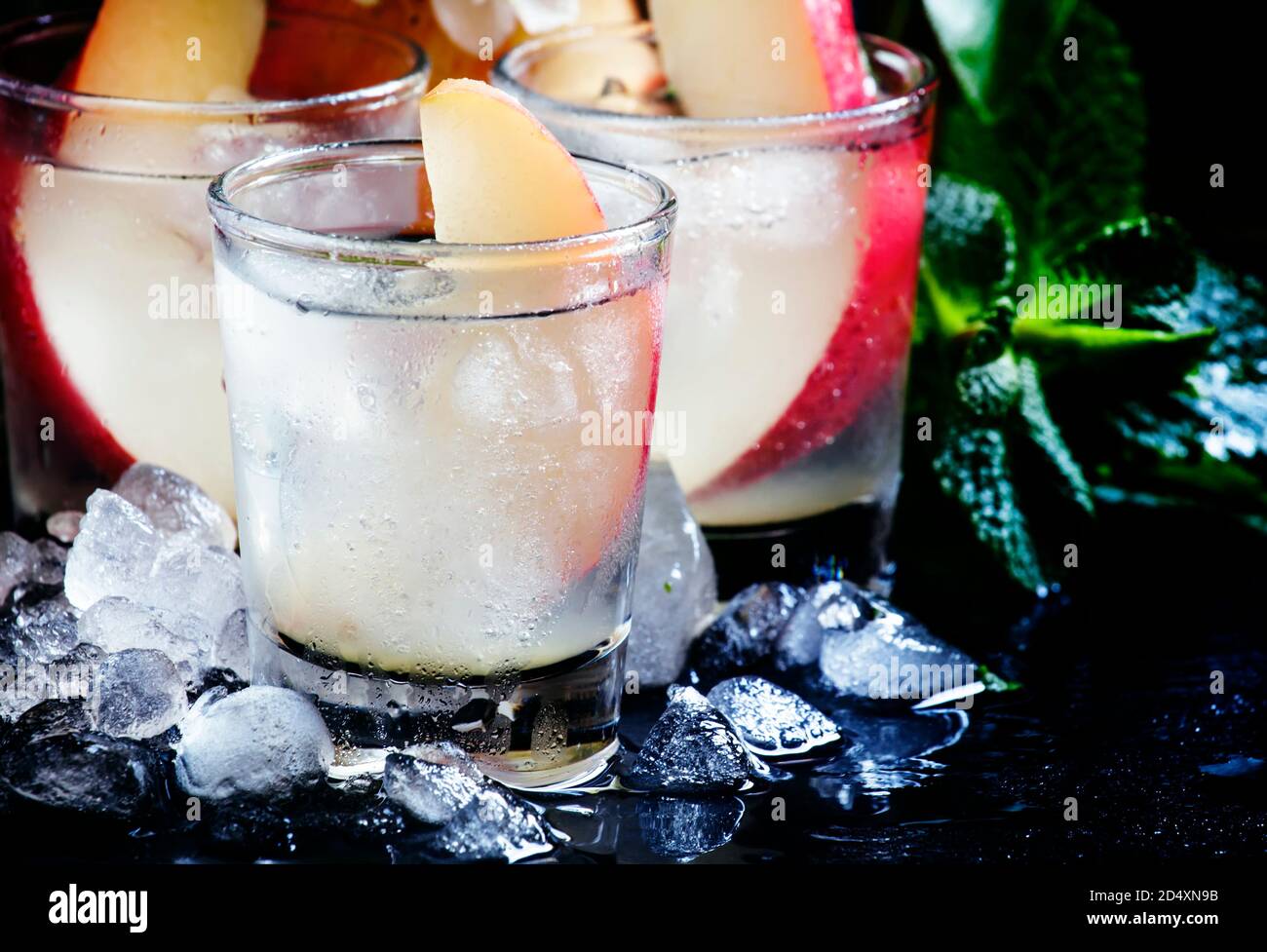 Alcoholic cocktail with pear, vodka, sprite, crushed ice and lime juice ...