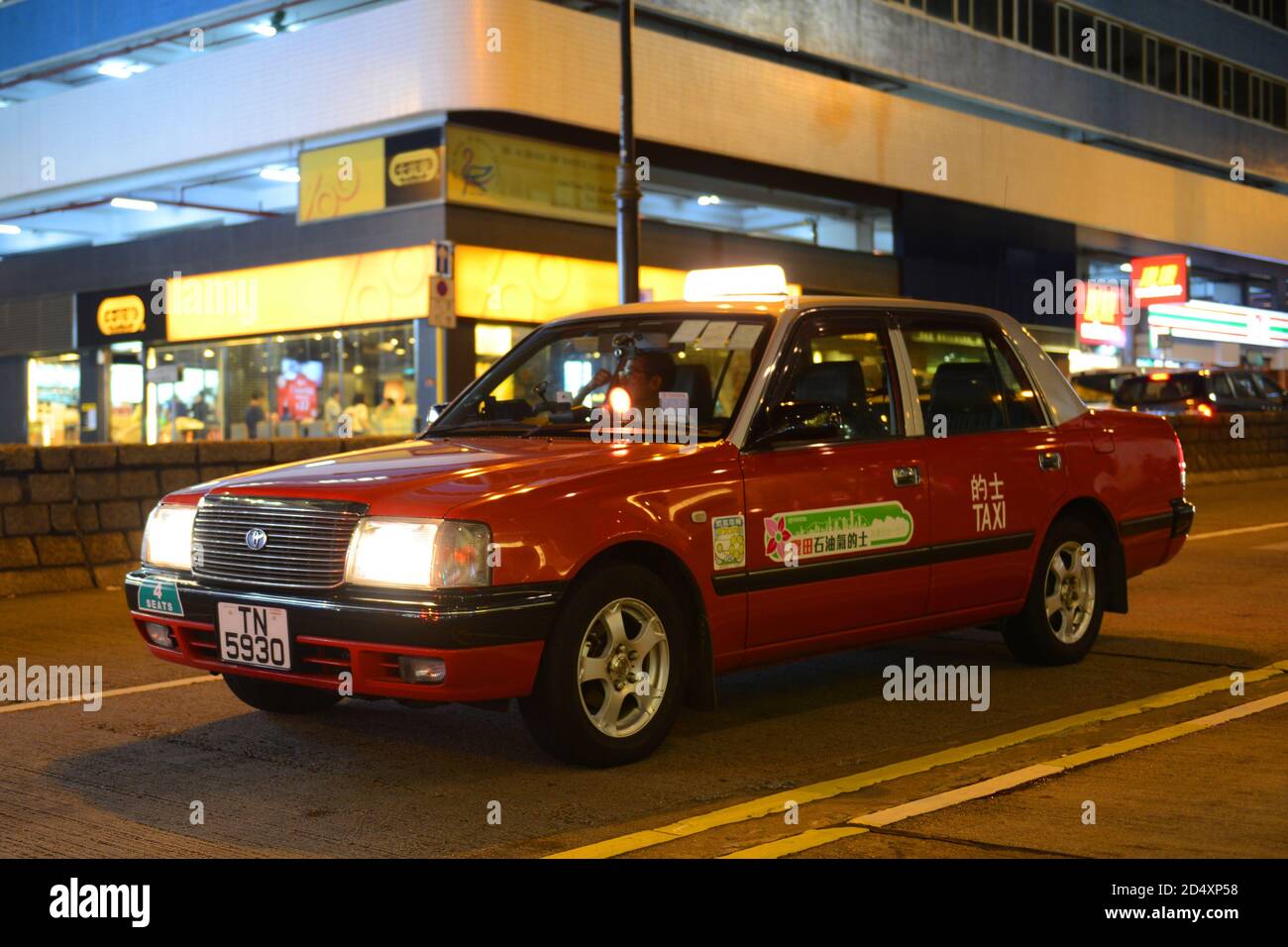 Hong Kong Urban red Toyota Crown Confort YXS10 four seats taxi at night ...