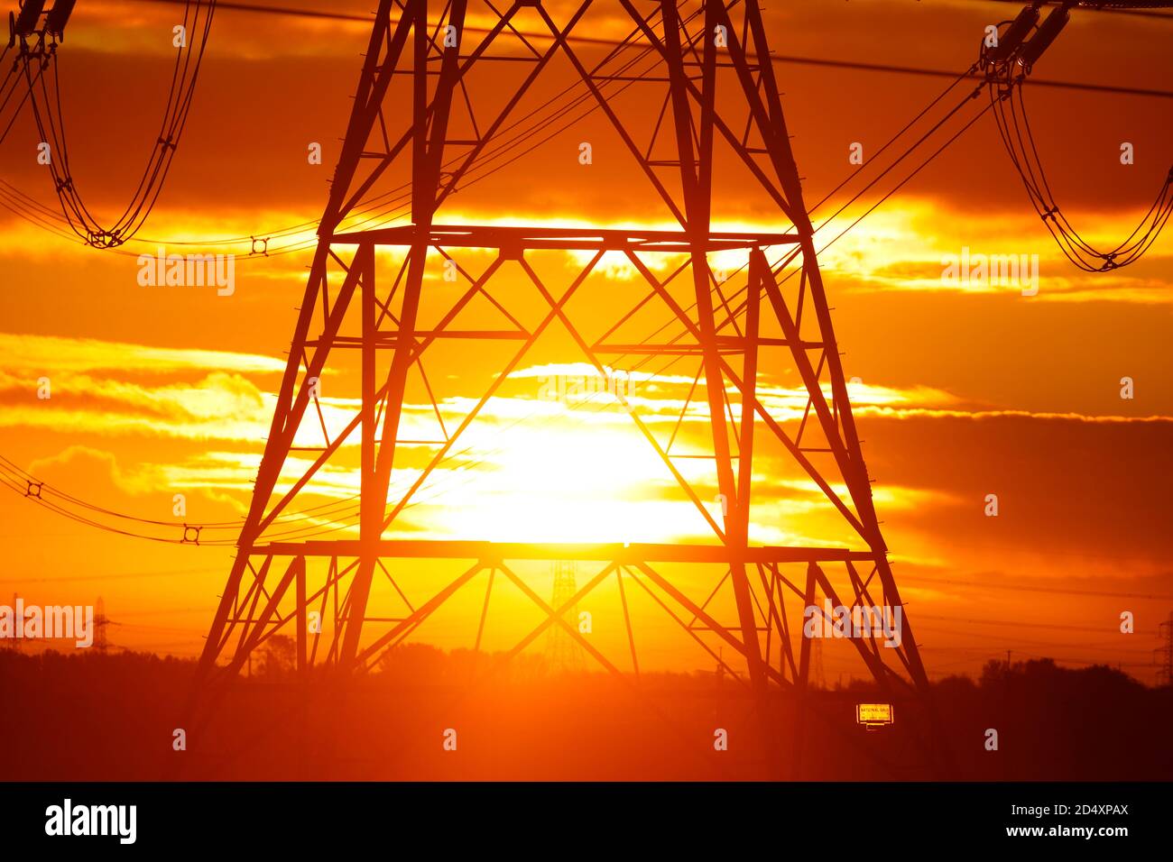 Pylons silhouetted against the sky during sunrise in Ferrybridge,West ...