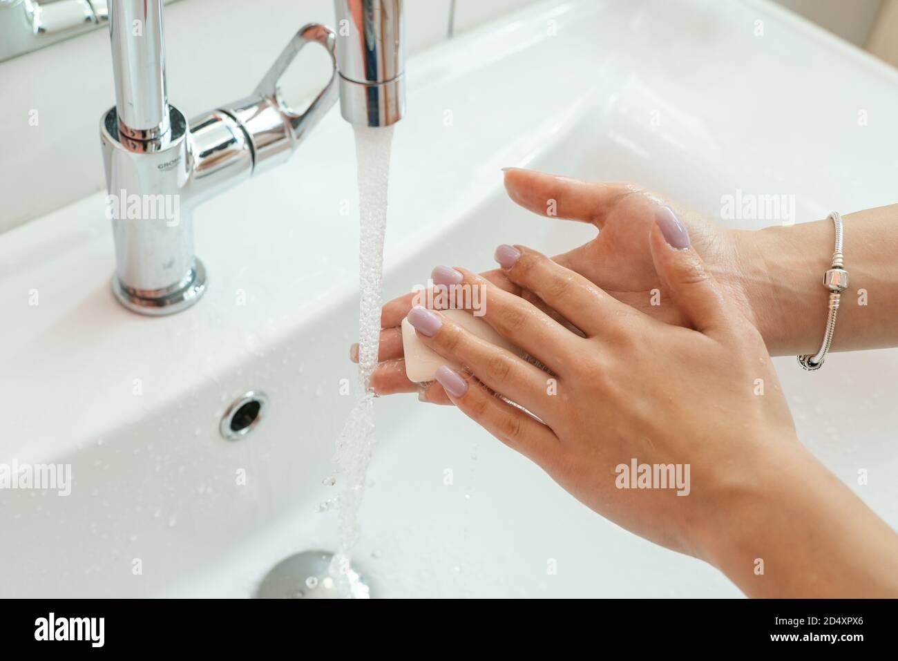 Young woman washing hands soap hi-res stock photography and images - Alamy