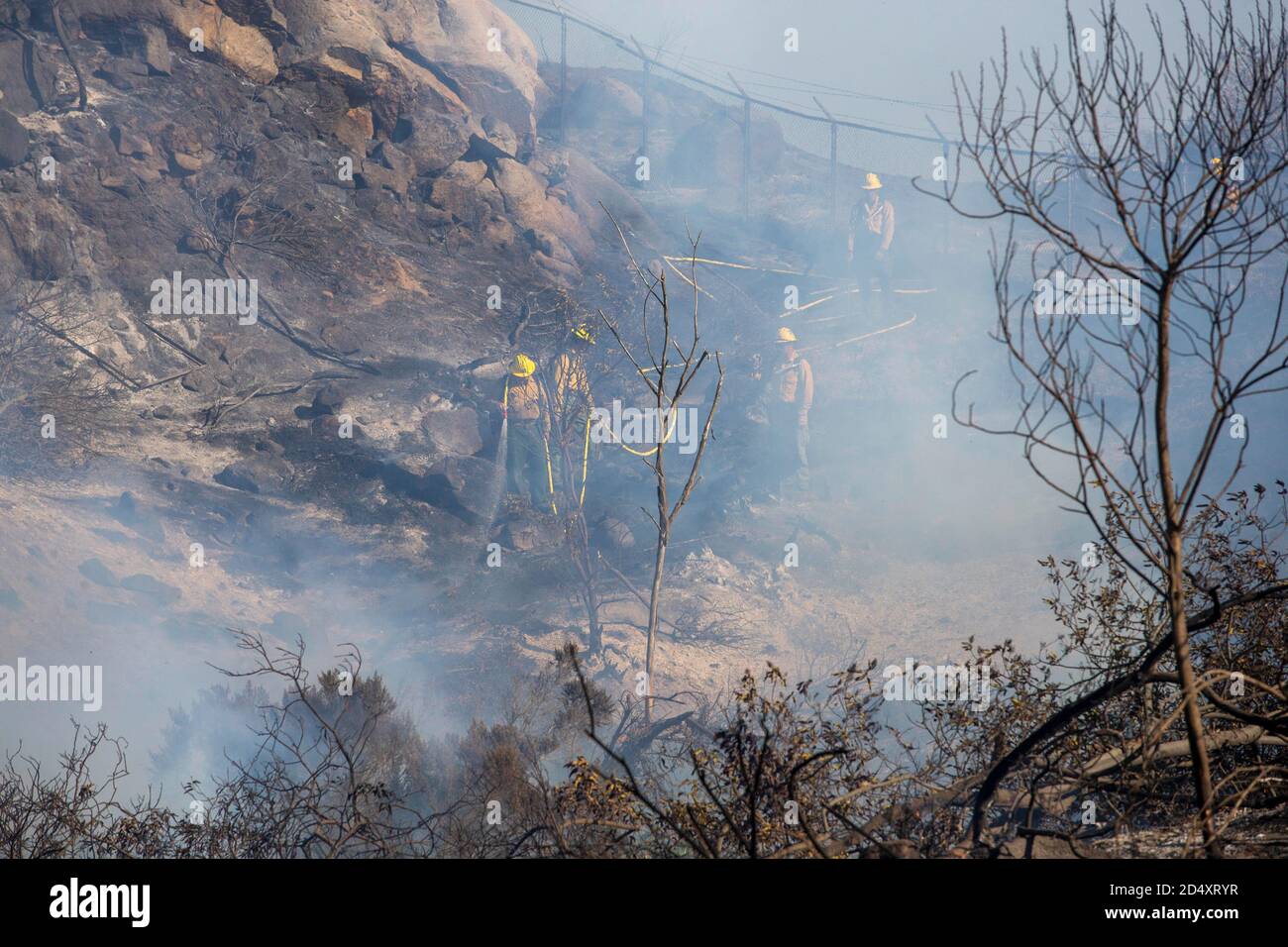 Firefighters with the Camp Pendleton Fire Department work together to ...