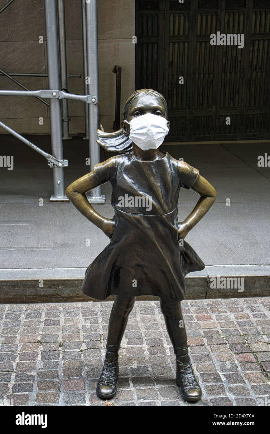 A bronze statue entitled "Fearless Girl". statue standing at its new ...