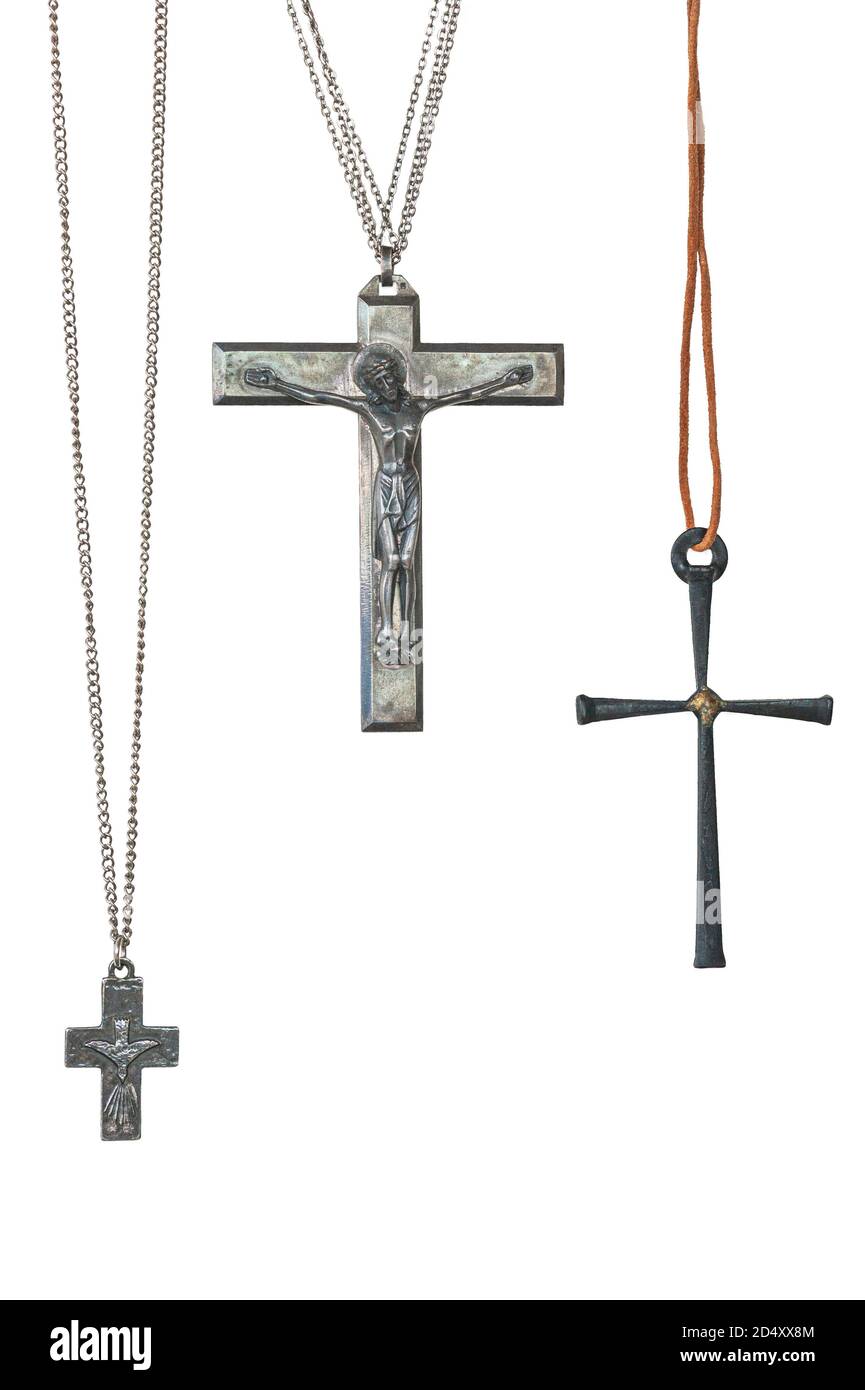 Three Christian crosses on chains or cords isolated. One with dove, the ...