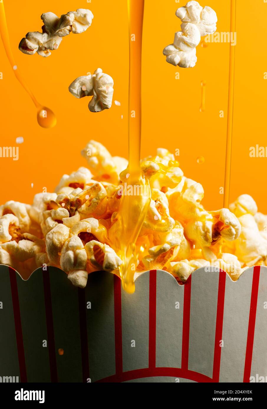 Concept: Popcorn explosion with splashing butter, flying popcorn and ...