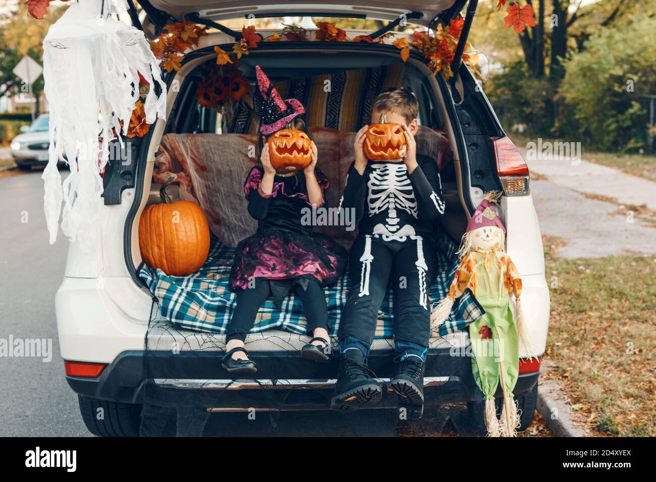 Trick or trunk. Siblings brother and sister celebrating Halloween in ...
