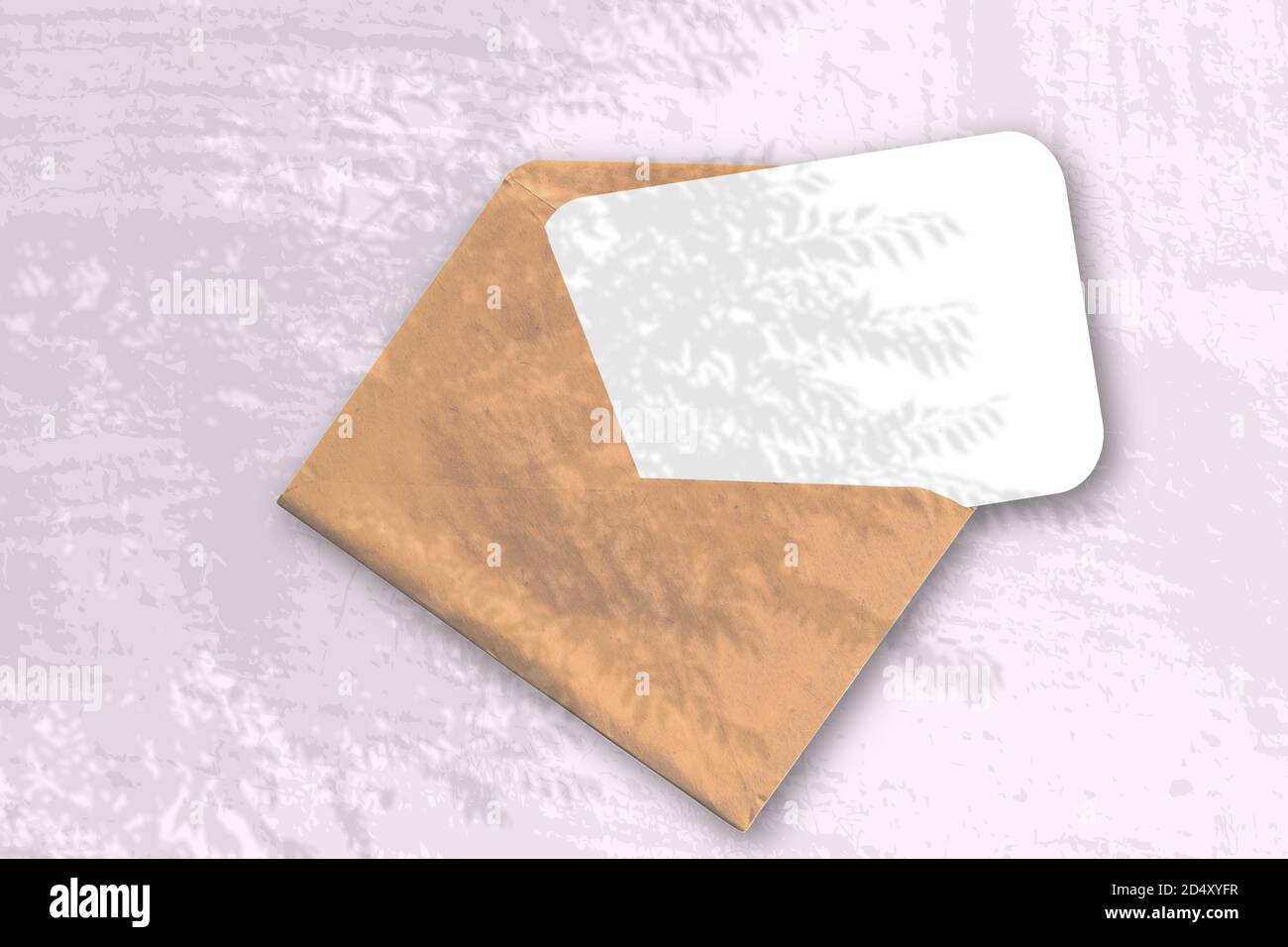An envelope with sheet of textured white paper on the pink background ...