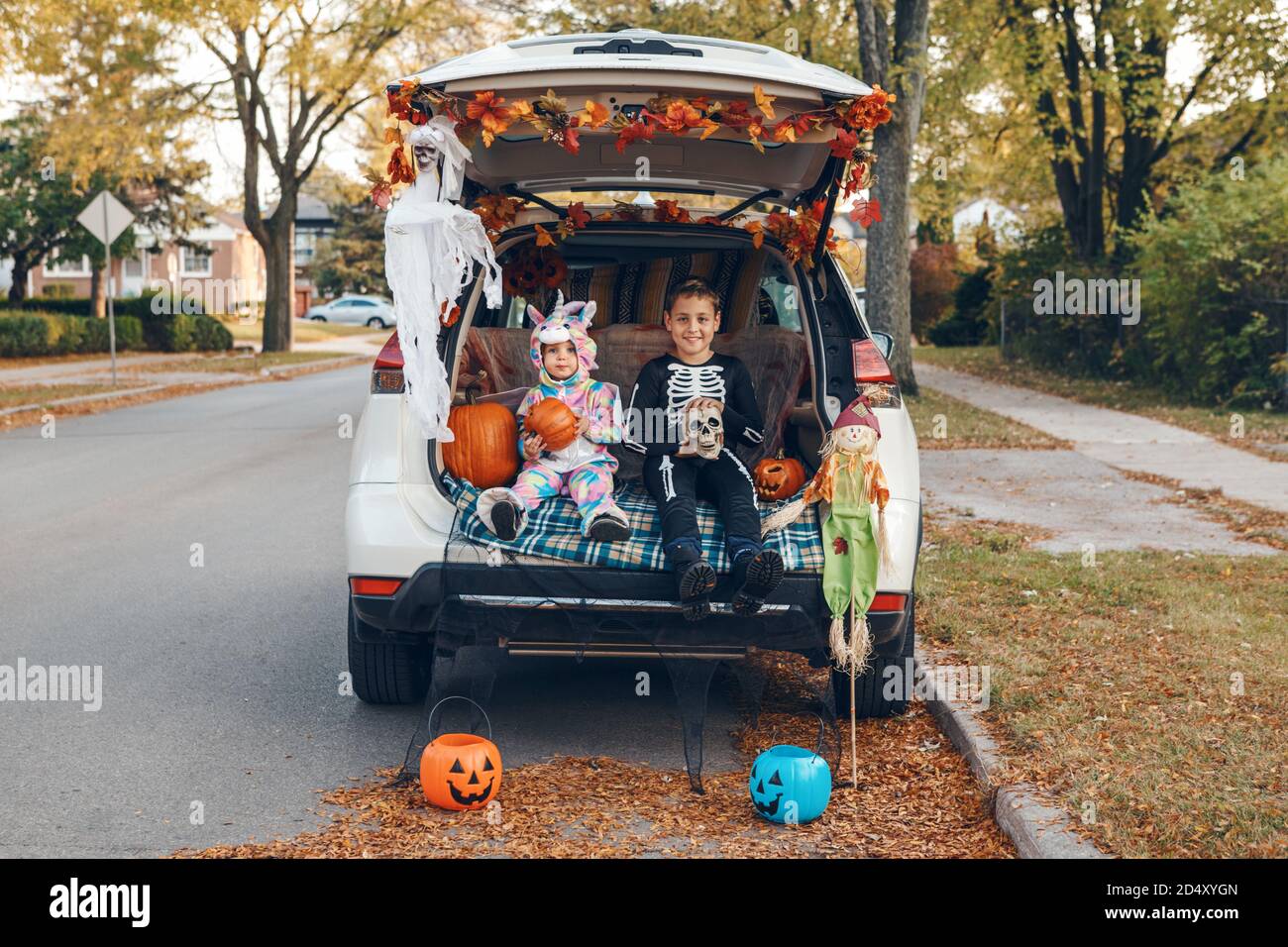 Trick o trunk. Siblings brother and sister celebrating Halloween in ...