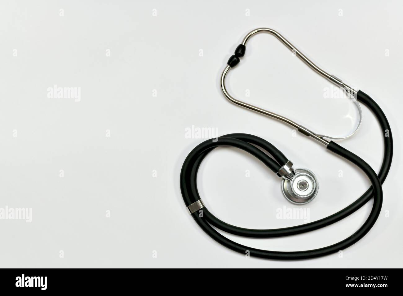 A medical stethoscope with a black hose, a membrane and headphone pads ...