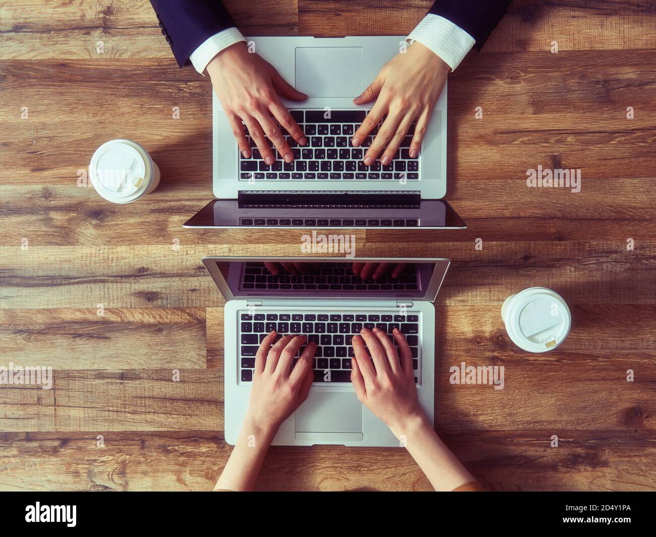 man and woman working on their computers. the view from the top. two ...