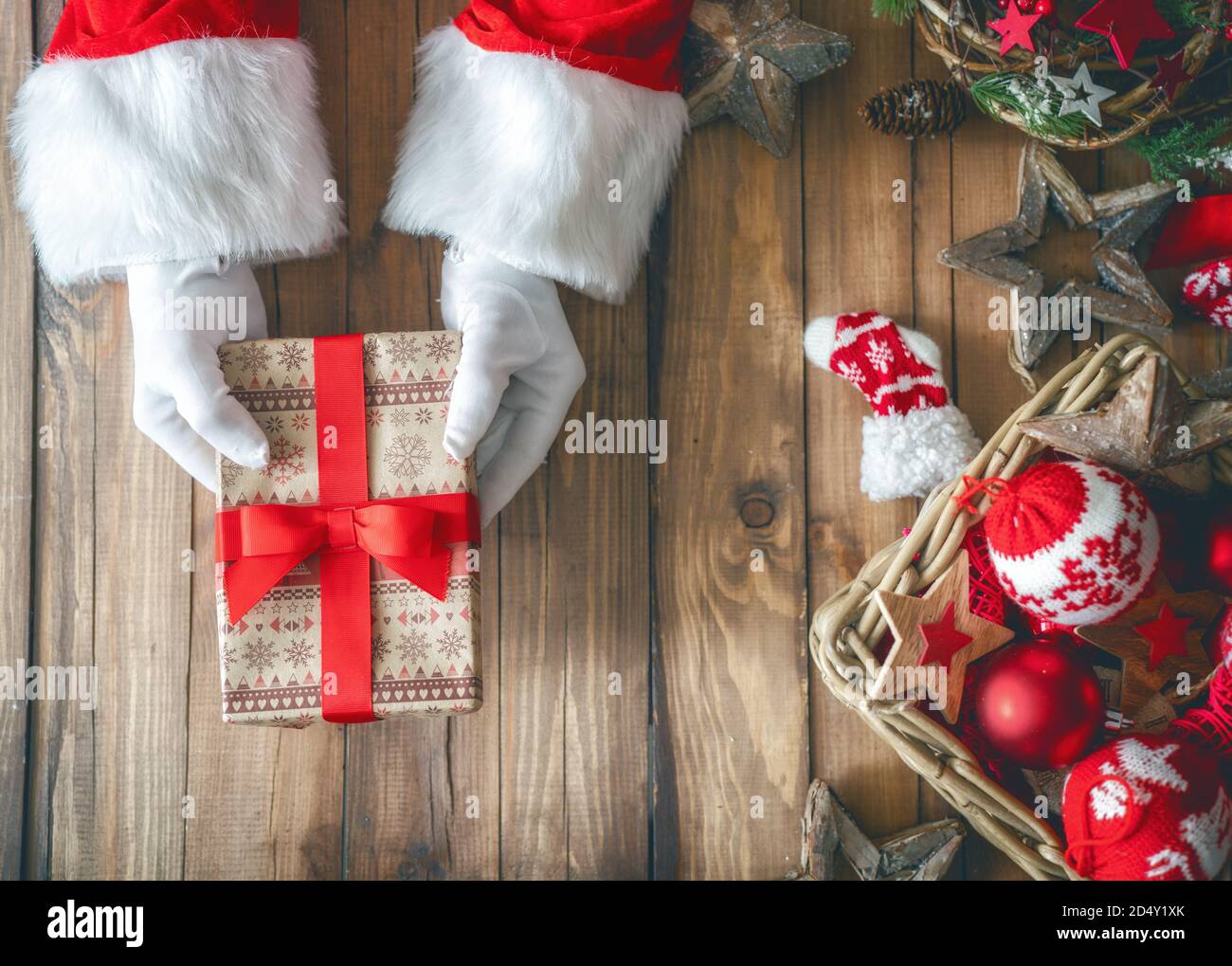 Hands of Santa Claus with Christmas present Stock Photo - Alamy
