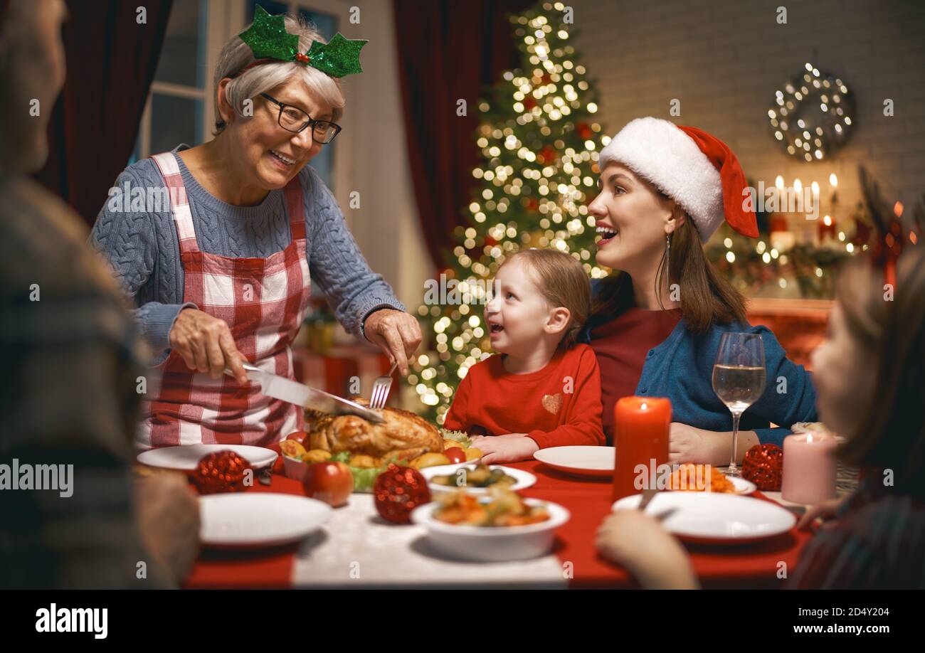 Merry Christmas! Happy family are having dinner at home. Celebration holiday and togetherness ...