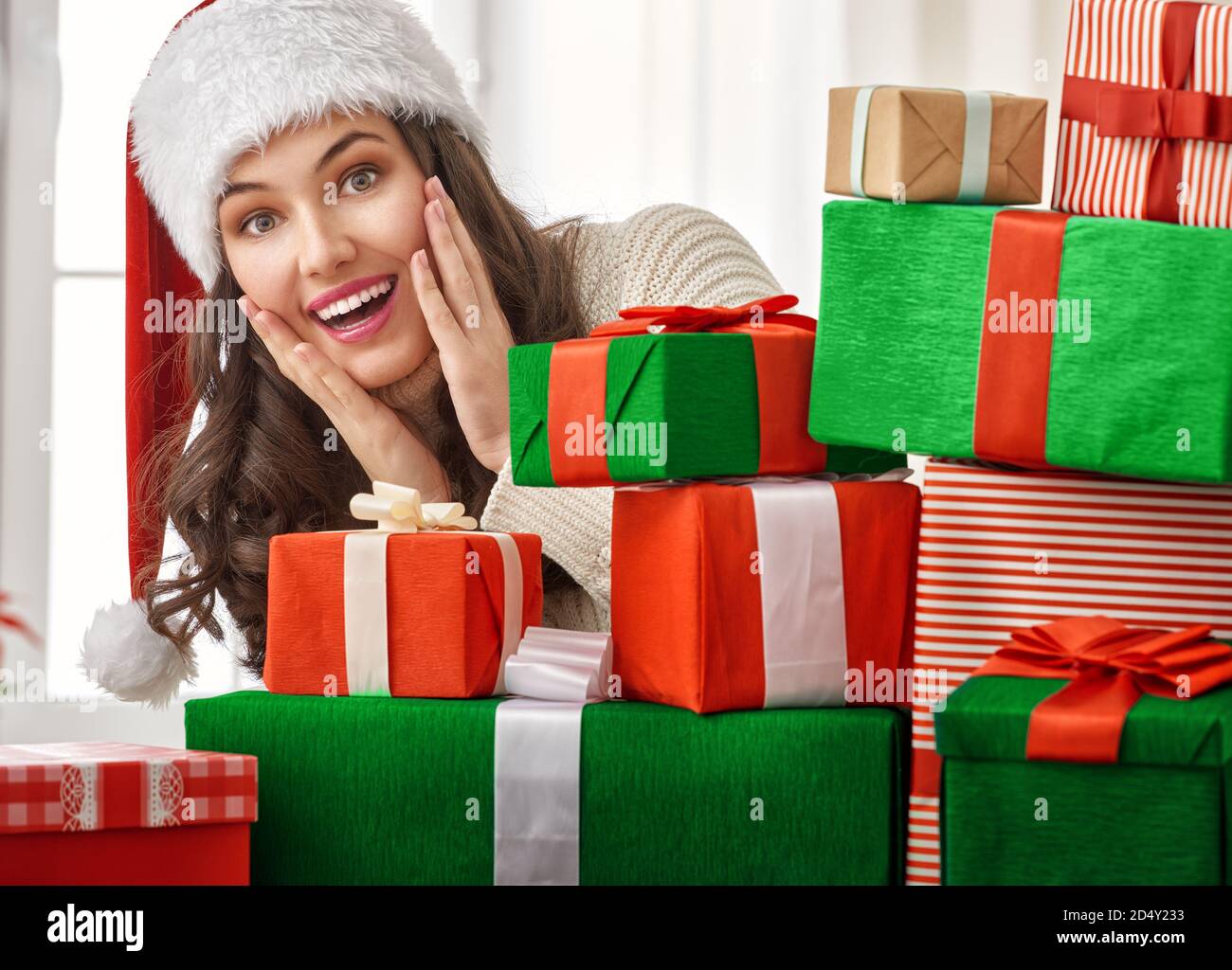 Beautiful young woman with gift boxes Stock Photo - Alamy