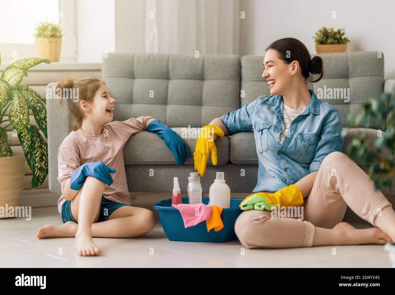 Happy family at home. Mother and daughter doing the cleaning in the ...